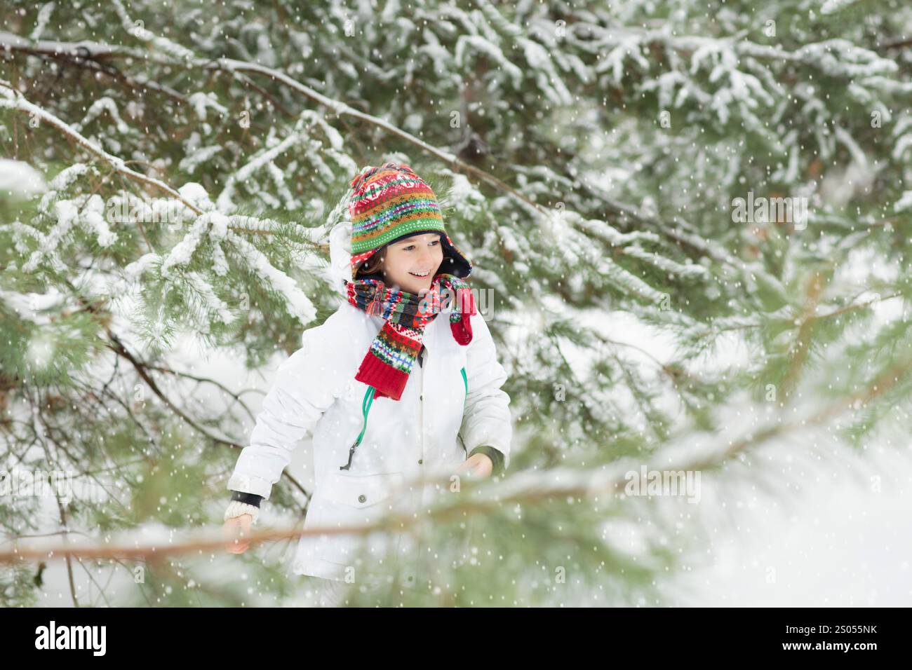 Kids play in snow in winter park. Children playing outdoors on snowy ...