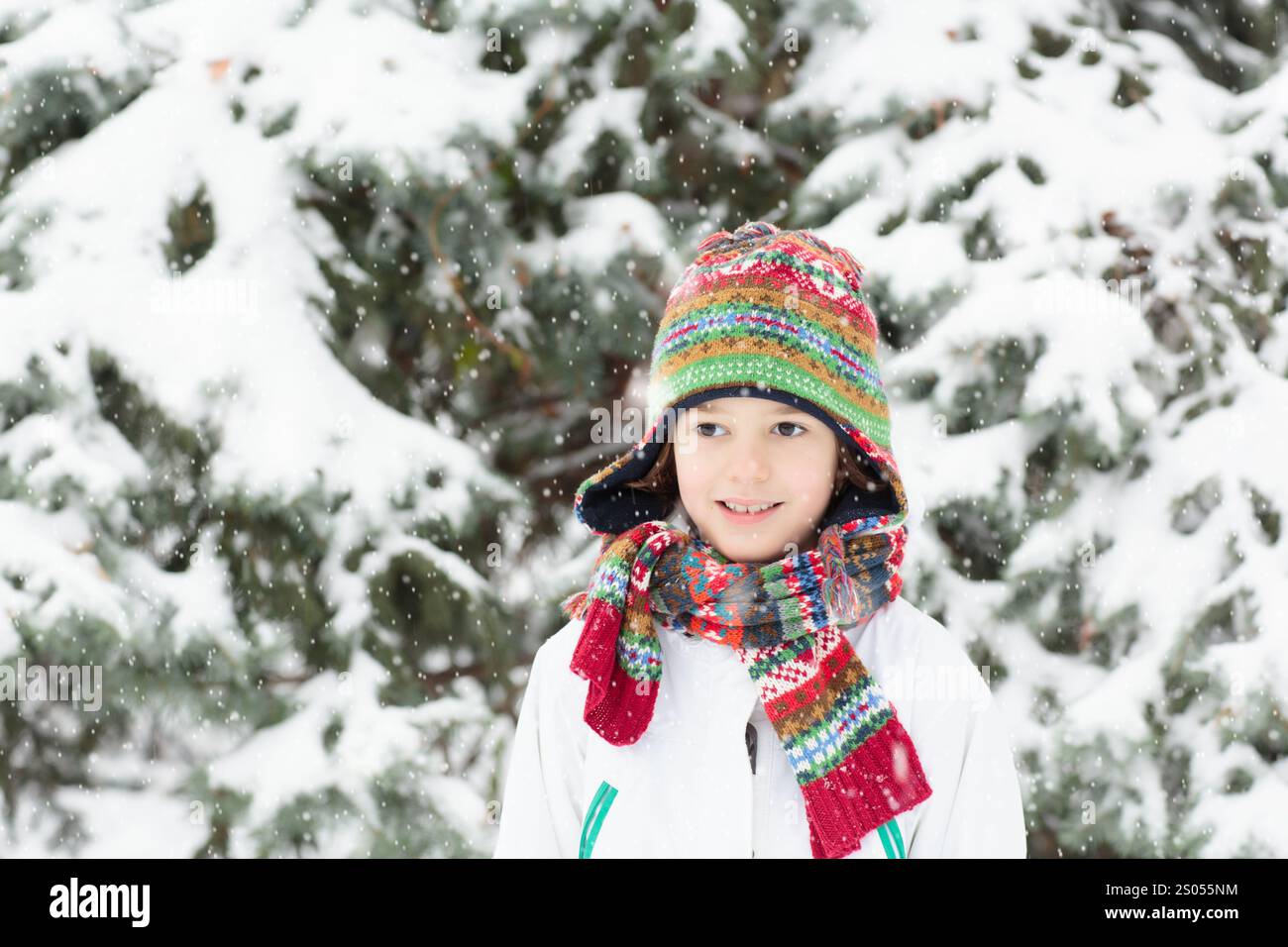 Kids play in snow in winter park. Children playing outdoors on snowy ...