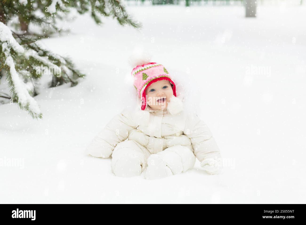 Kids play in snow in winter park. Children playing outdoors on snowy ...