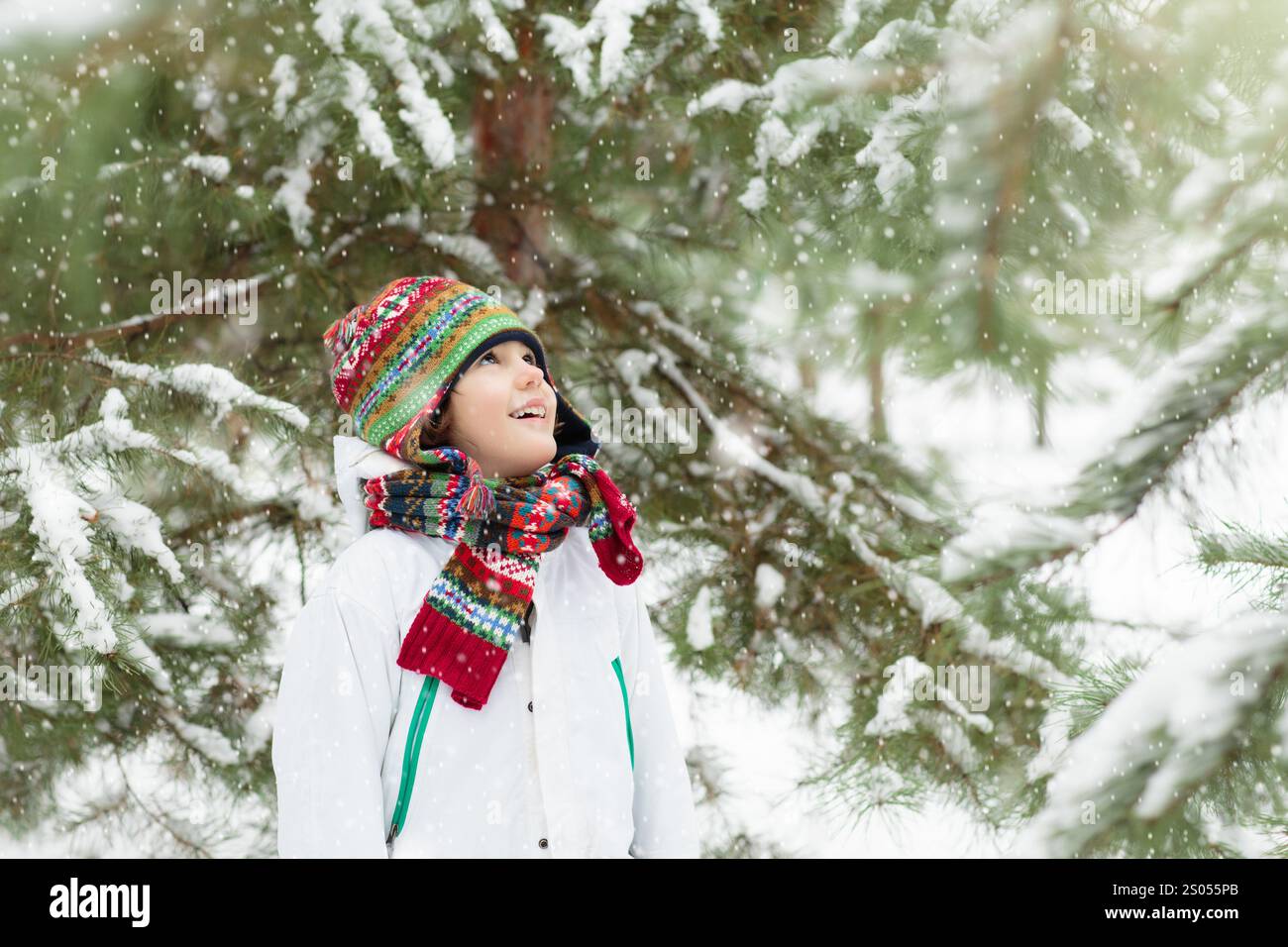 Kids play in snow in winter park. Children playing outdoors on snowy ...