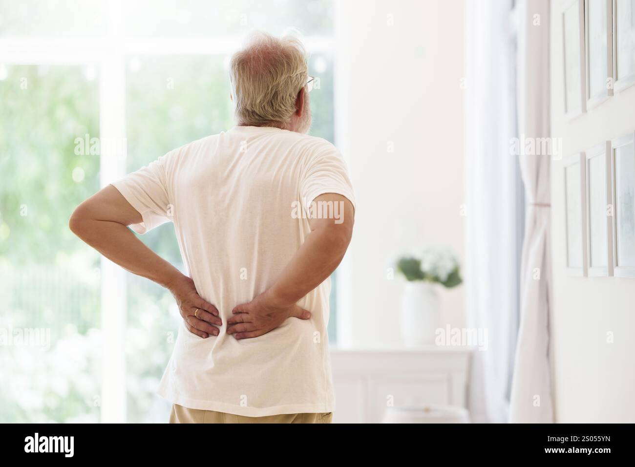 Senior man in pain. Retired man suffering from chest, back and stomach ...