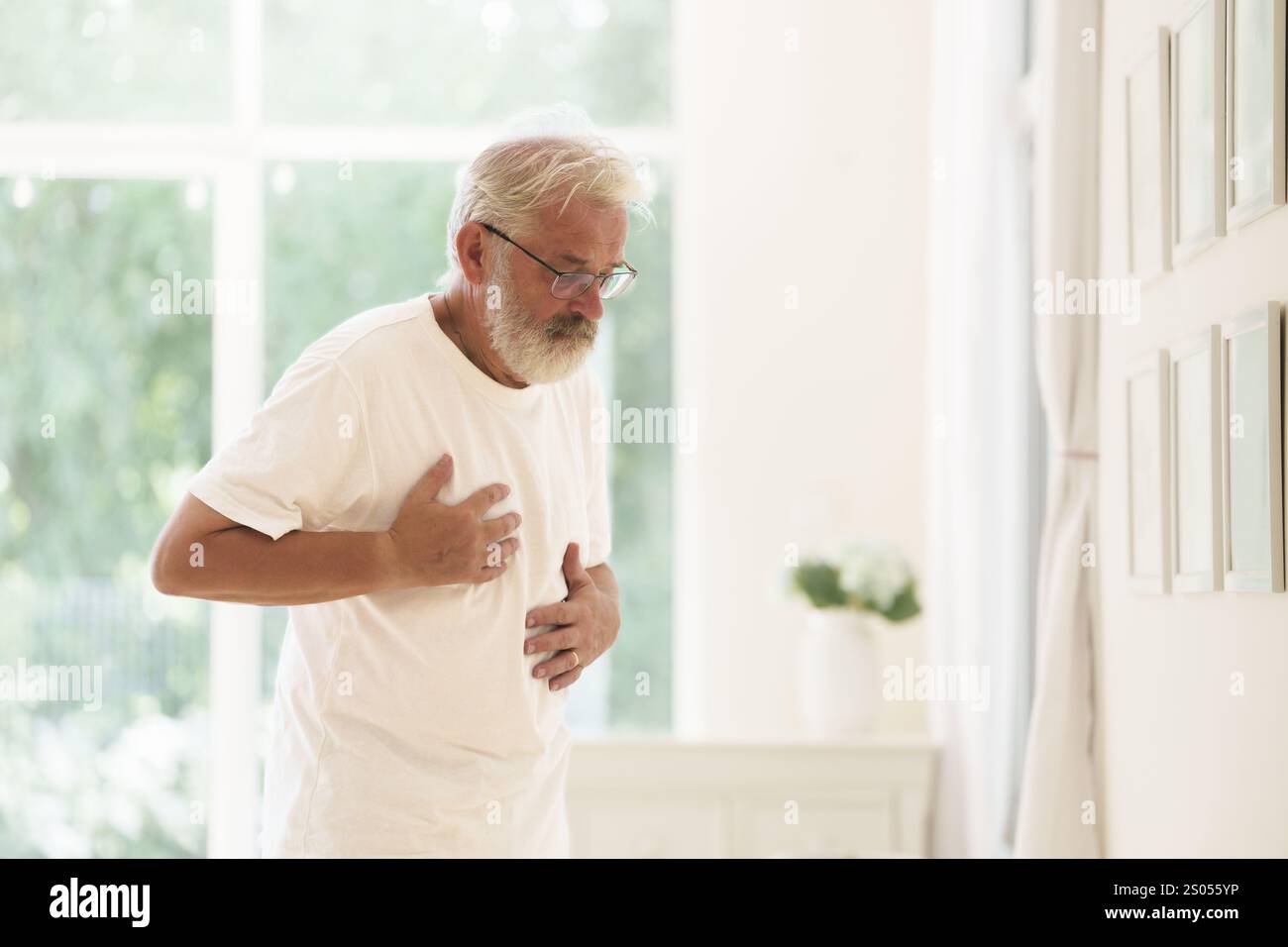 Senior man in pain. Retired man suffering from chest, back and stomach ...