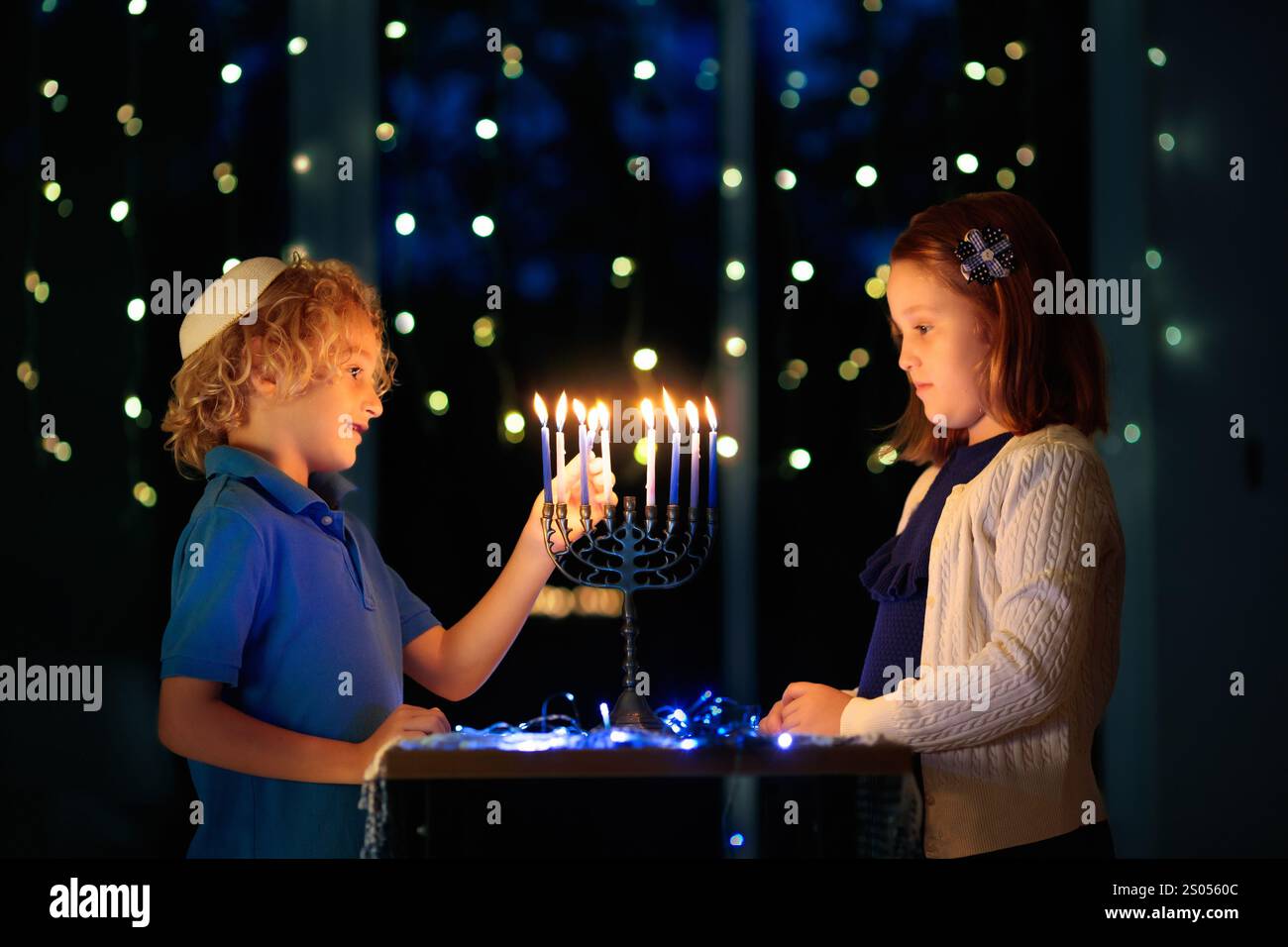 Kids celebrating Hanukkah. Jewish festival of lights. Children lighting ...