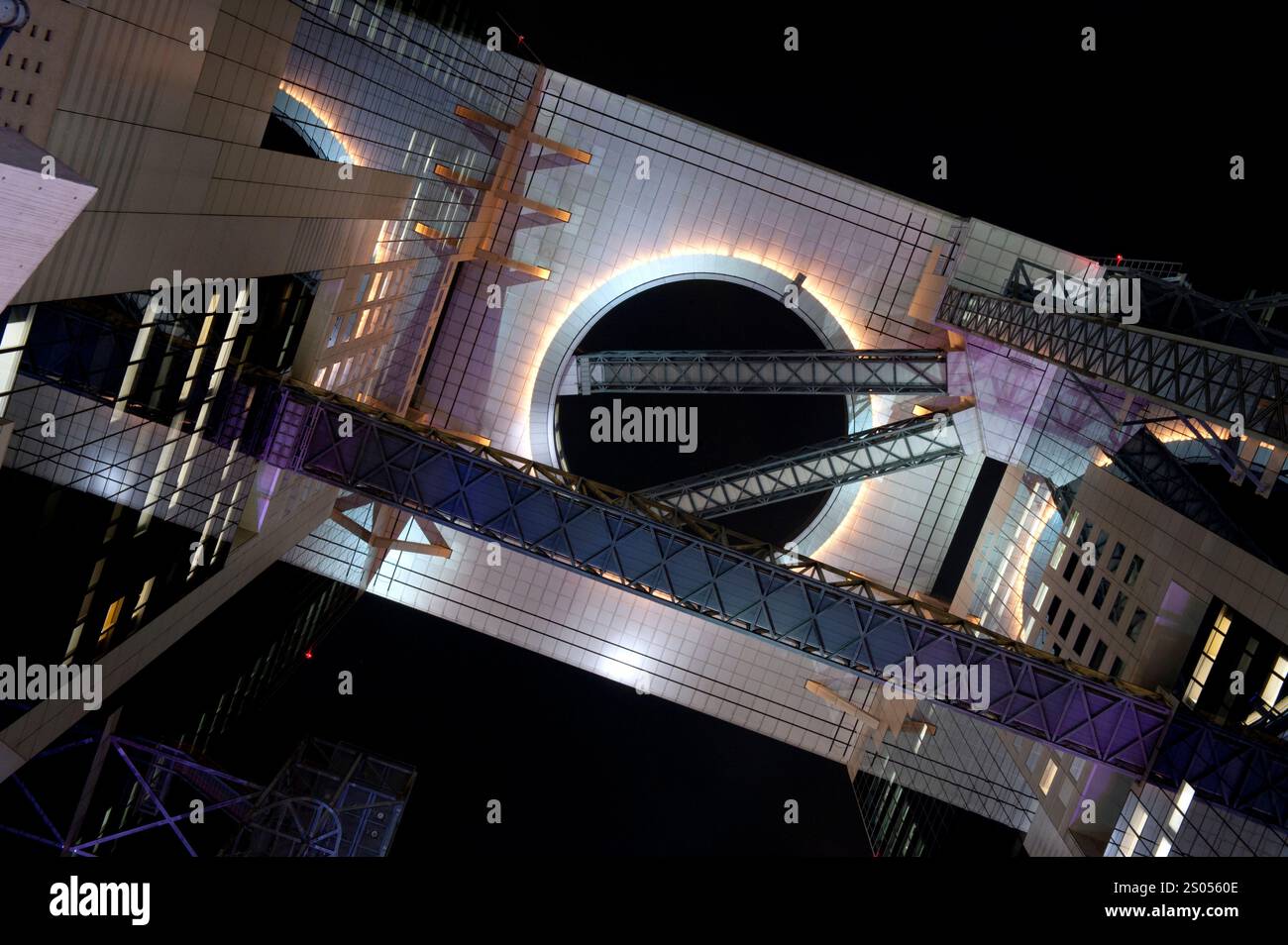 Night view looking up at the illuminated corona between the high-rise ...