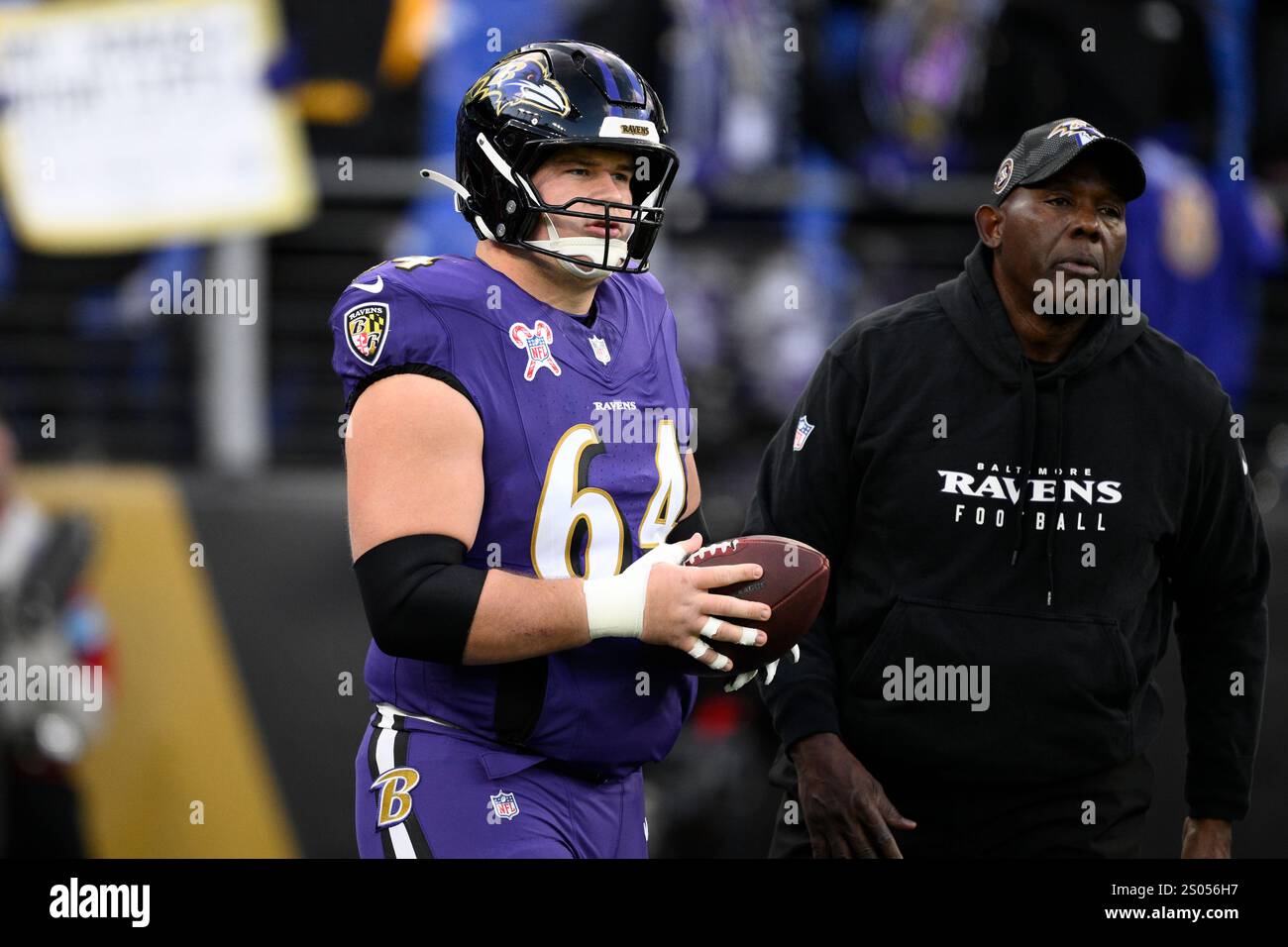 Baltimore Ravens center Tyler Linderbaum (64) works out before an NFL ...
