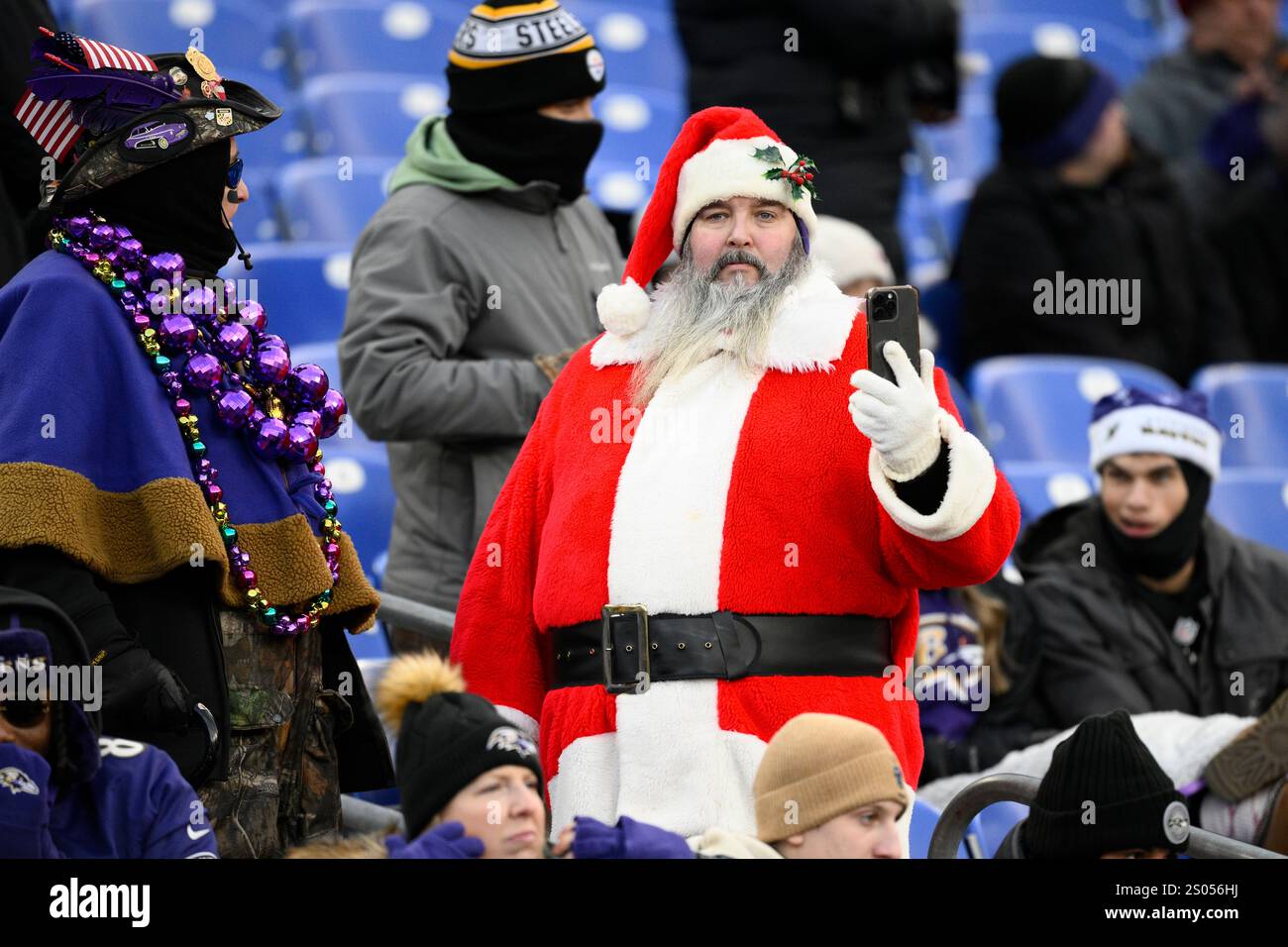 Spectator dressed as Santa Claus looks on before an NFL football game ...