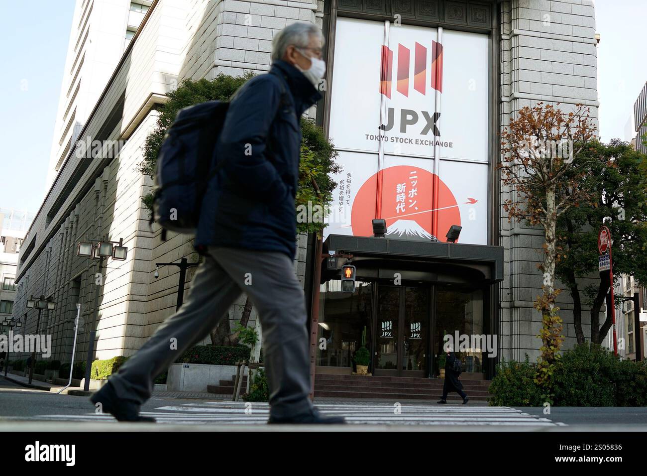 People walk in front of Tokyo Stock Exchange building Wednesday, Dec ...