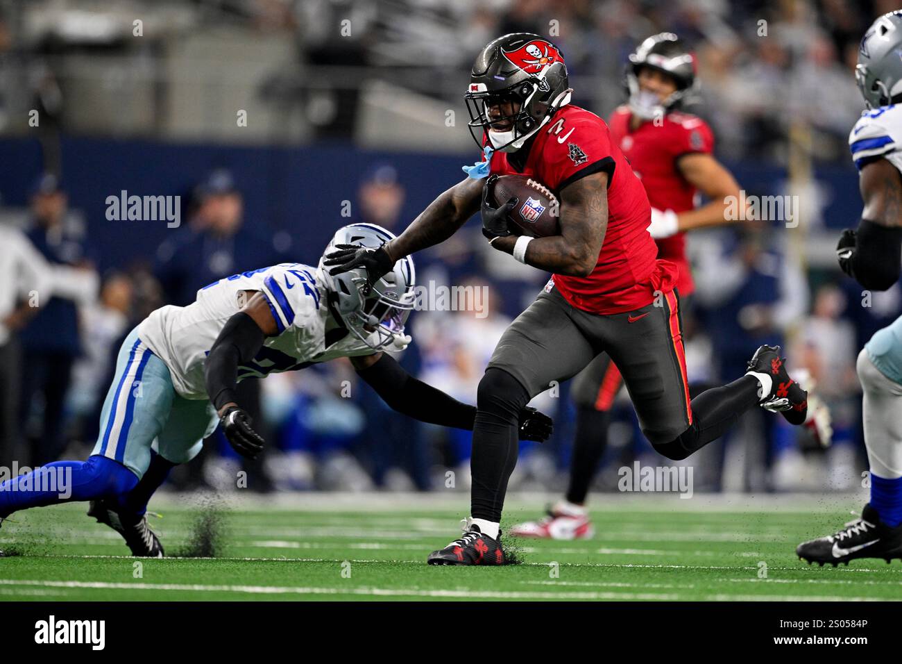 Tampa Bay Buccaneers running back Bucky Irving (7) eludes the tackle of ...