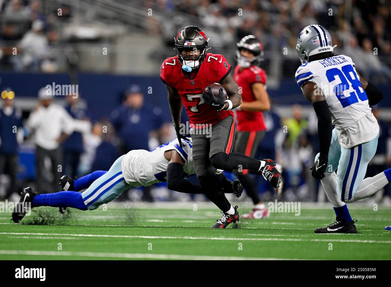 Tampa Bay Buccaneers running back Bucky Irving (7) eludes the tackle of ...