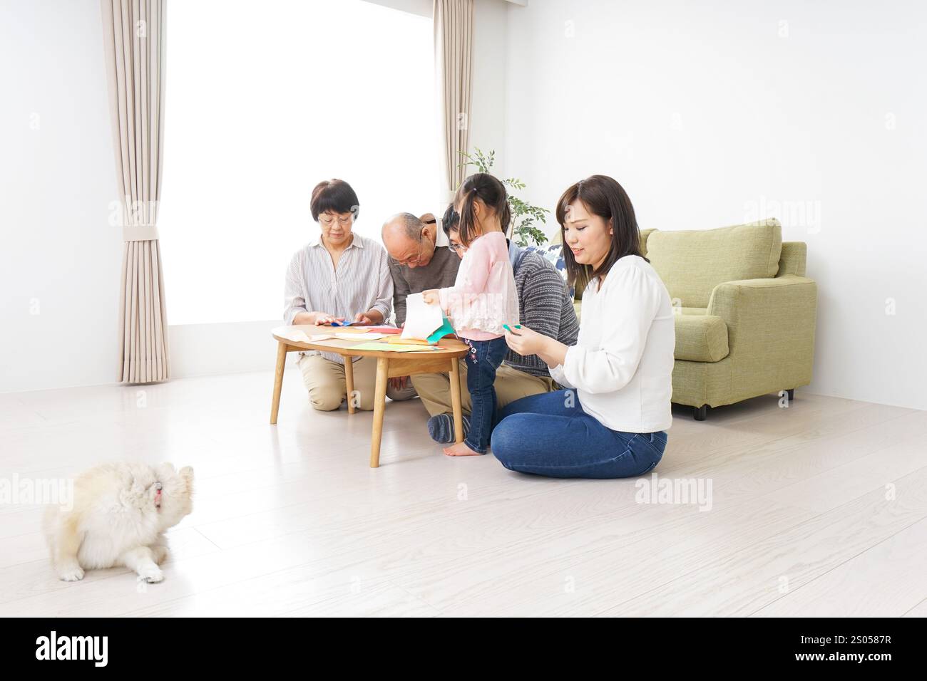 Children and family playing with origami Stock Photo - Alamy