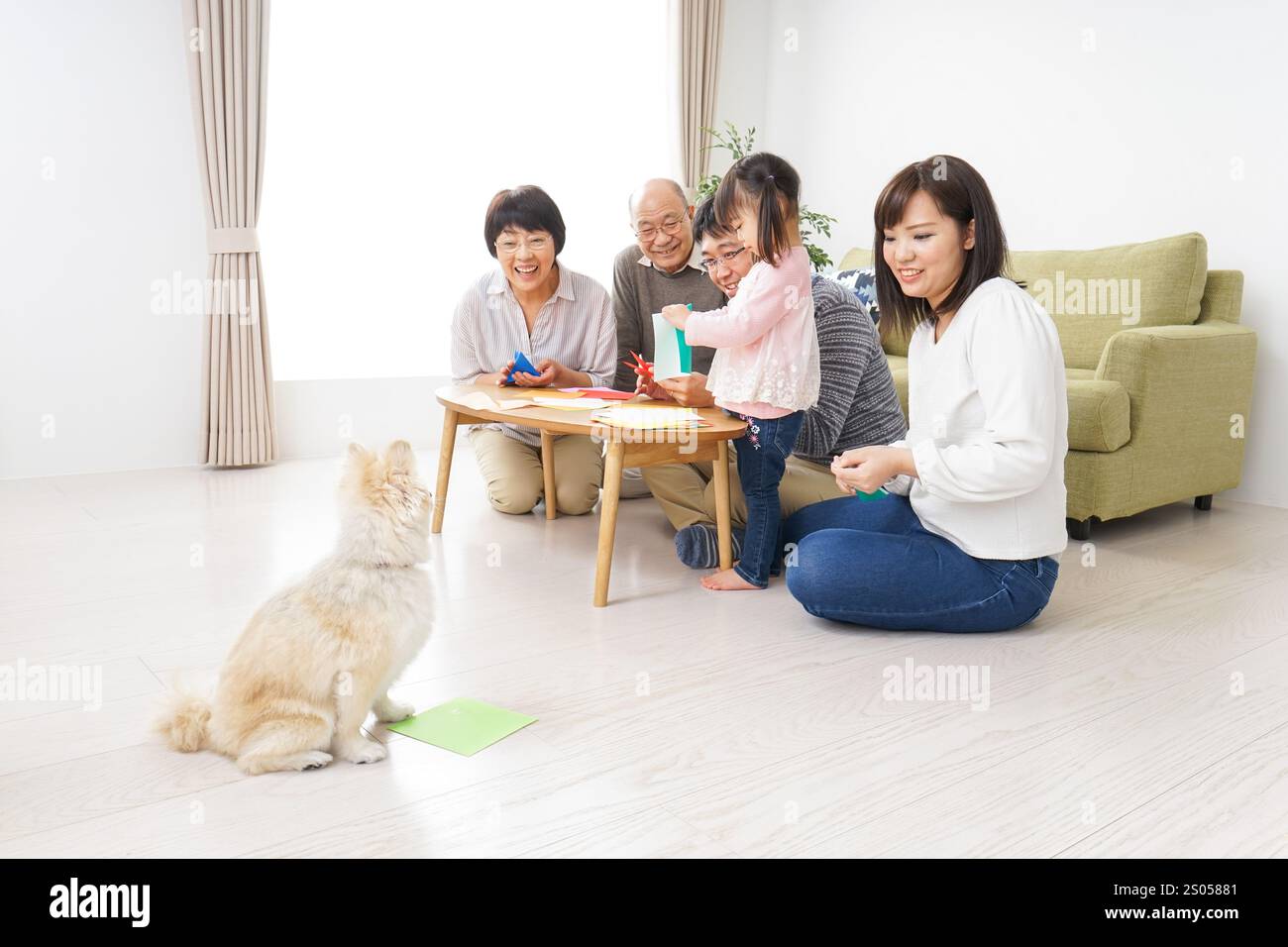 Children and family playing with origami Stock Photo - Alamy