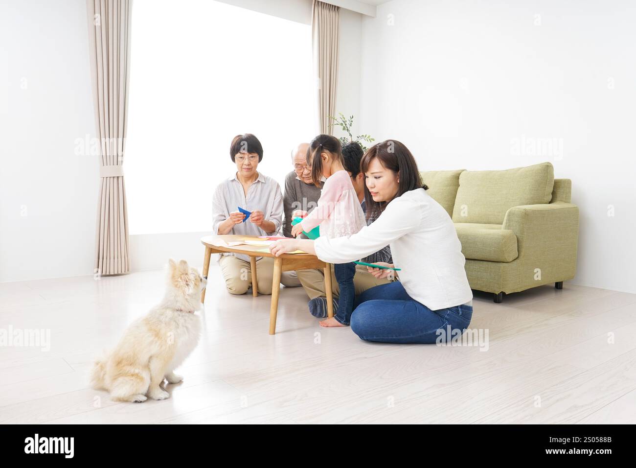 Children and family playing with origami Stock Photo - Alamy