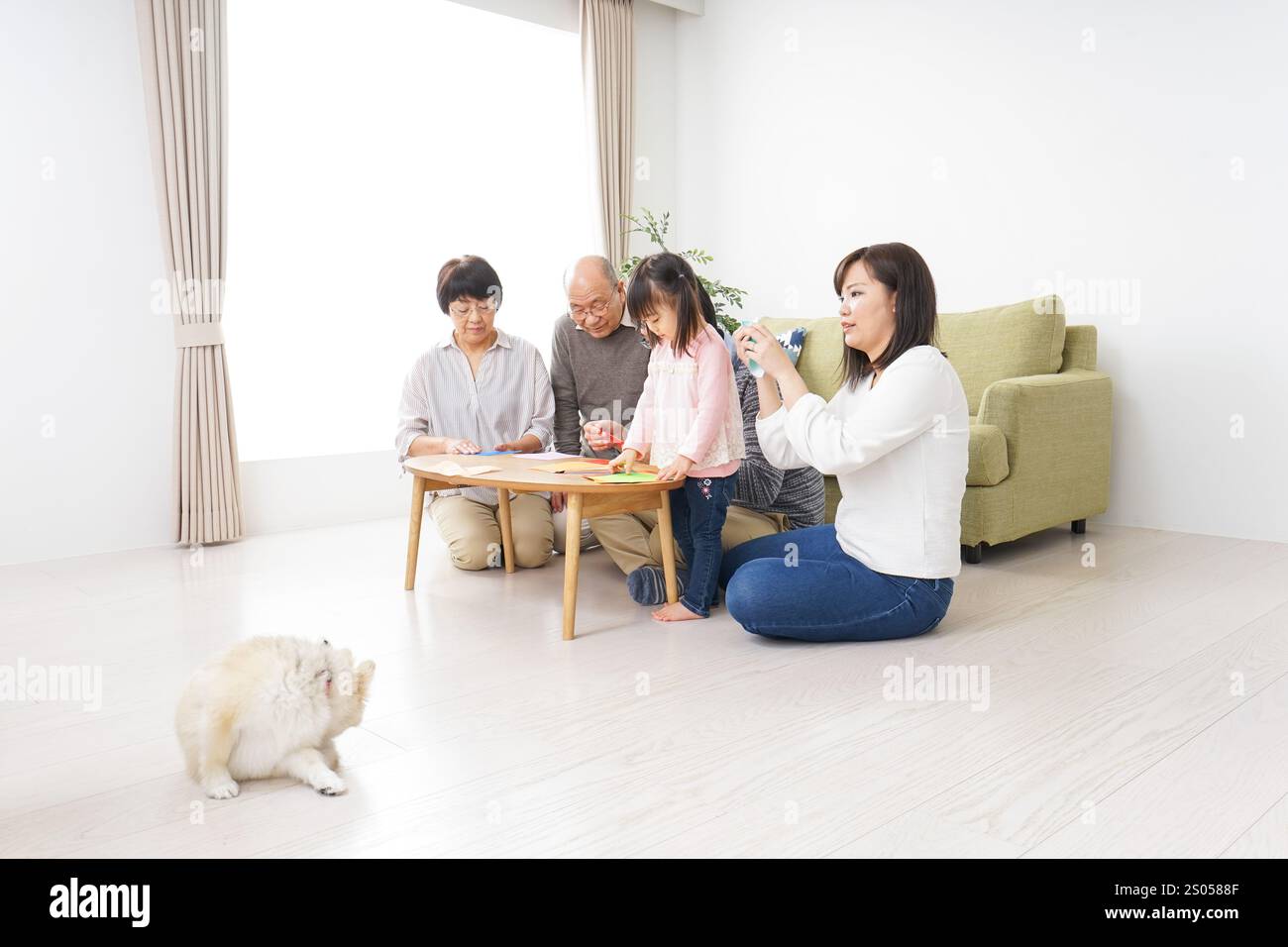 Children and family playing with origami Stock Photo - Alamy