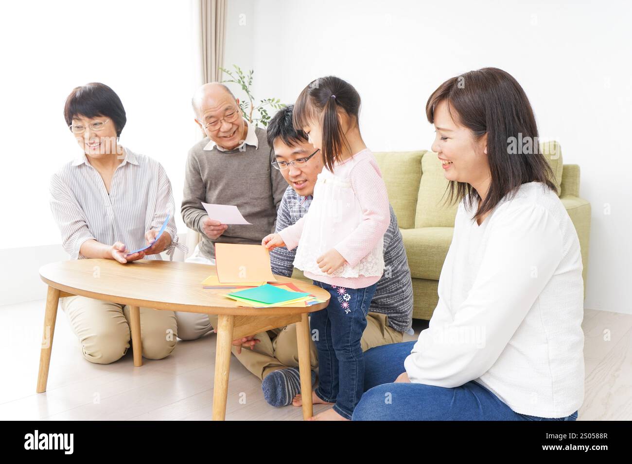 Children and family playing with origami Stock Photo - Alamy
