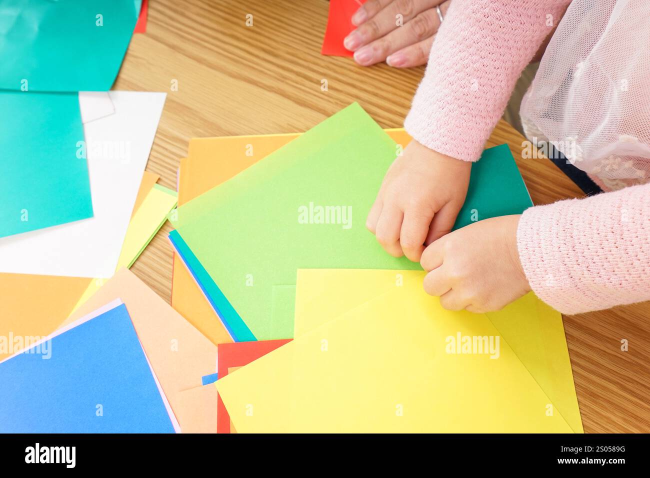 Child doing origami Stock Photo - Alamy