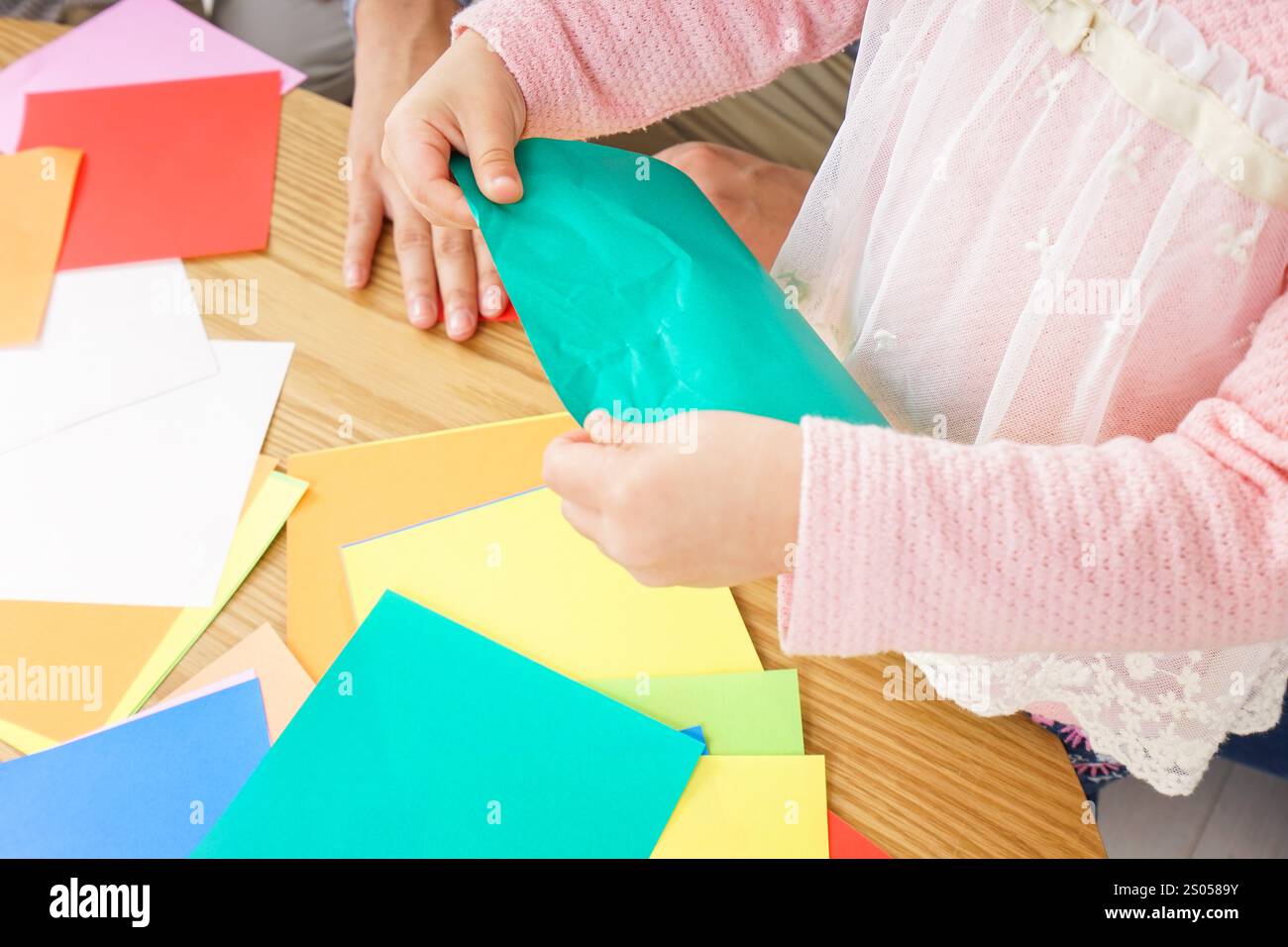 Child doing origami Stock Photo - Alamy