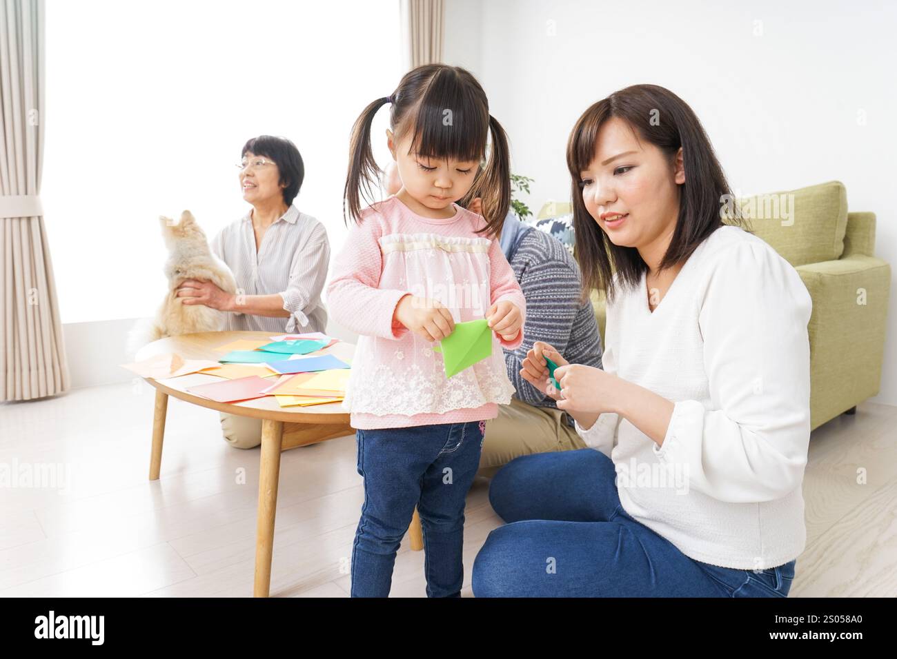 Children and family playing with origami Stock Photo - Alamy