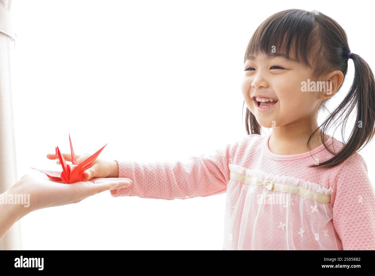 Child holding origami of vine Stock Photo - Alamy
