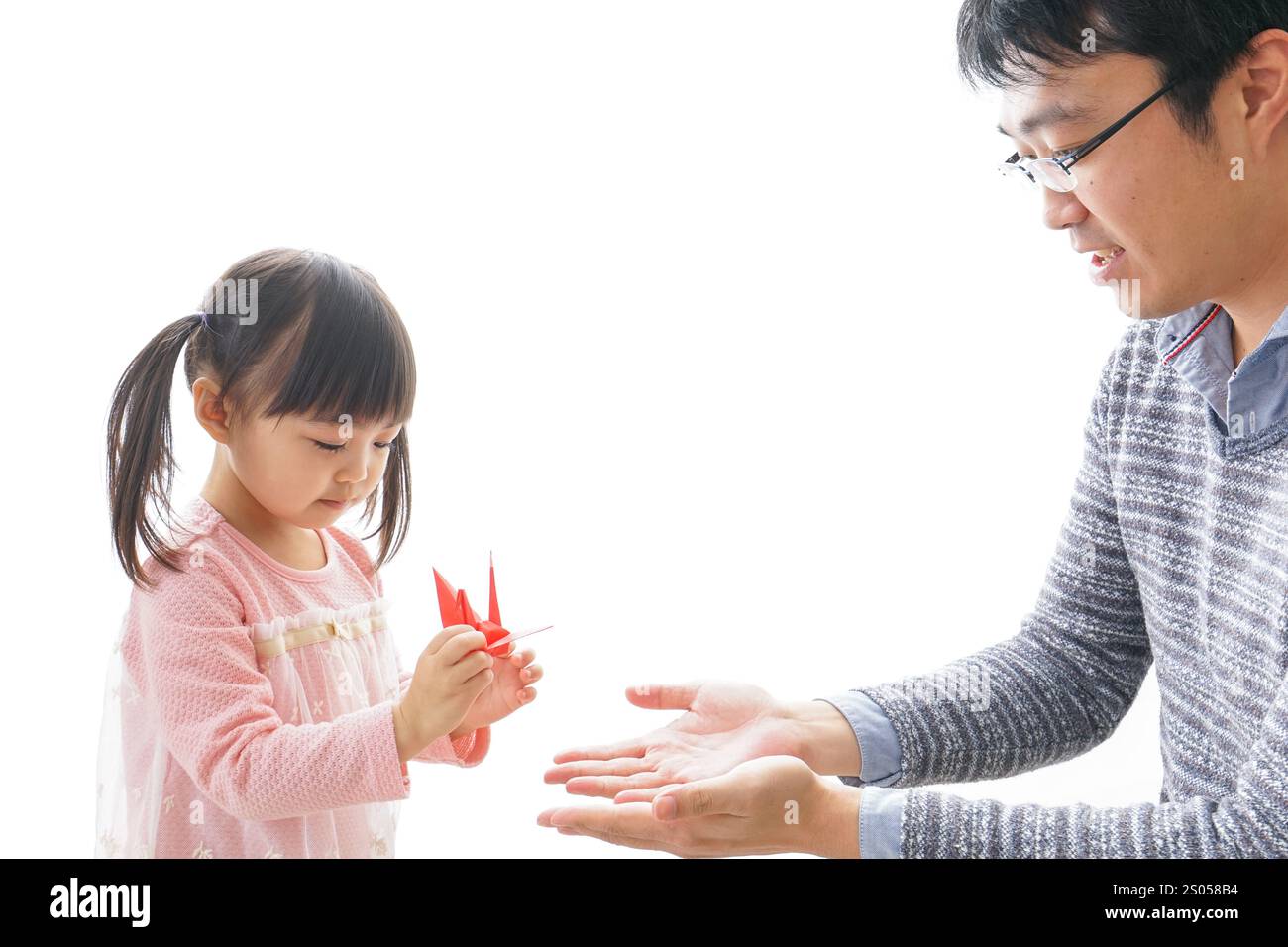 Child and father doing Origami Stock Photo - Alamy