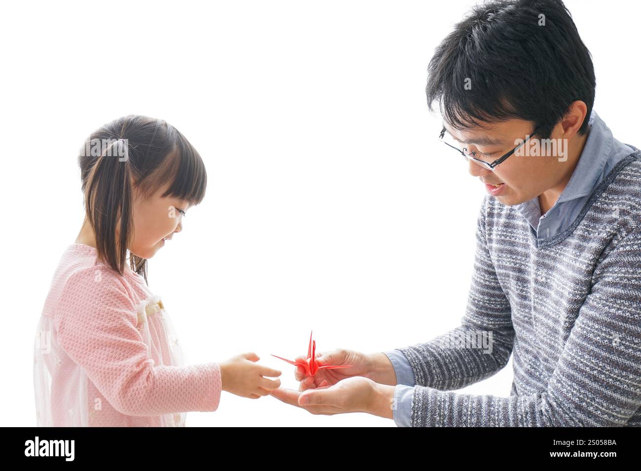 Child and father doing Origami Stock Photo - Alamy
