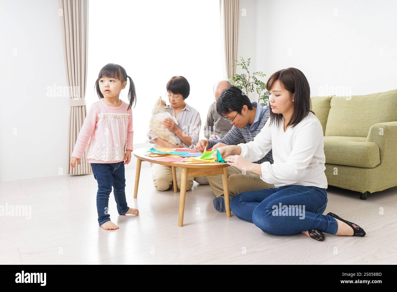 Children and family playing with origami Stock Photo - Alamy