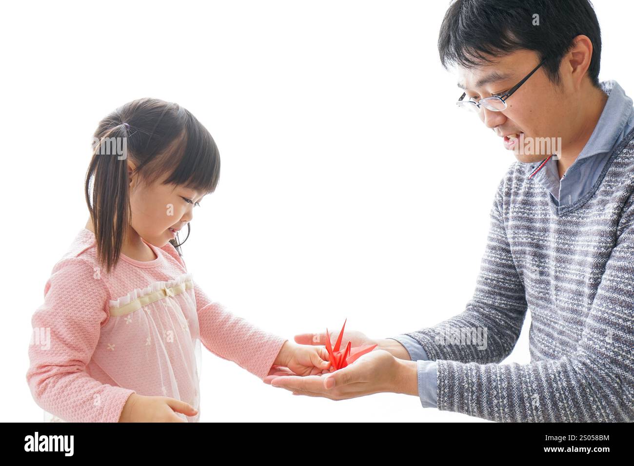Child and father doing Origami Stock Photo - Alamy