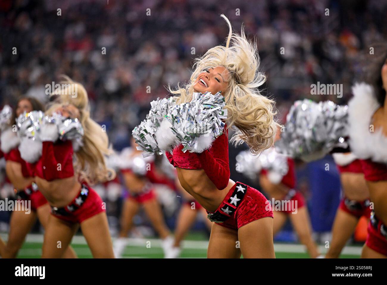 The Dallas Cowboys Cheerleaders perform in their holiday costumes at ...