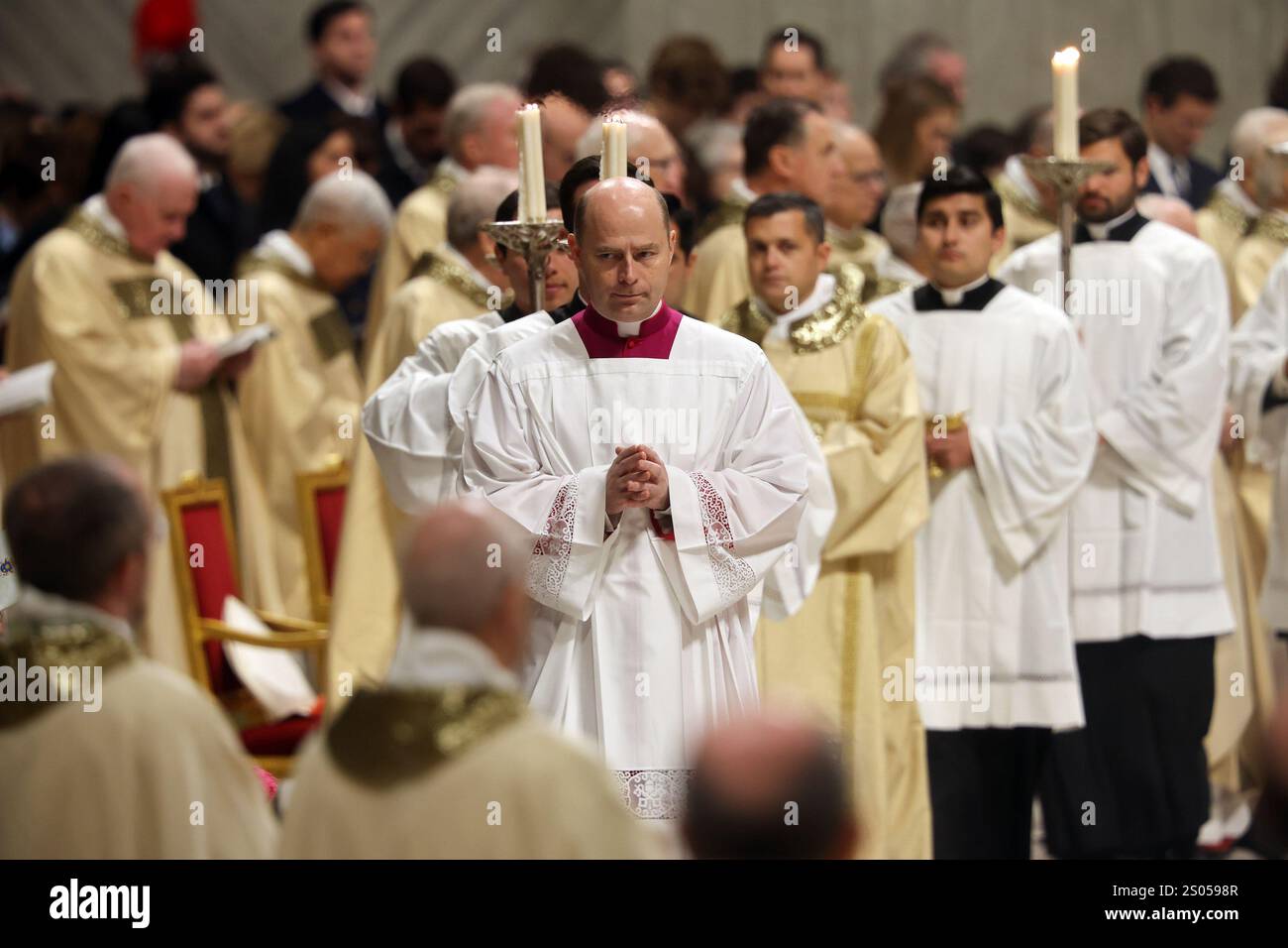 Rome, Italy. 24th Dec, 2024. Priests with candles in procession during ...