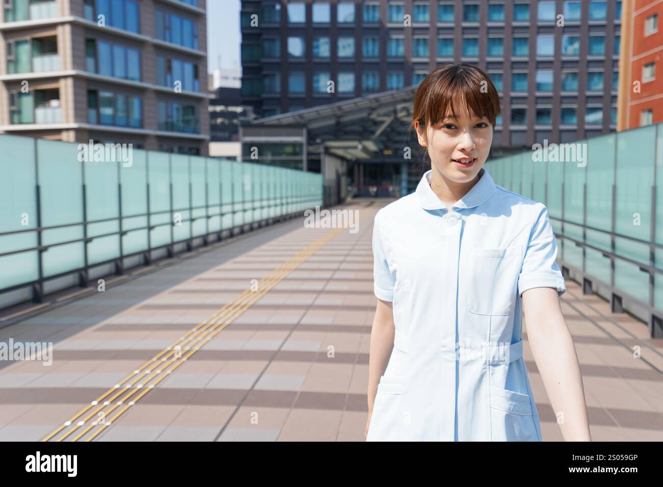Nurse walking outside Stock Photo - Alamy