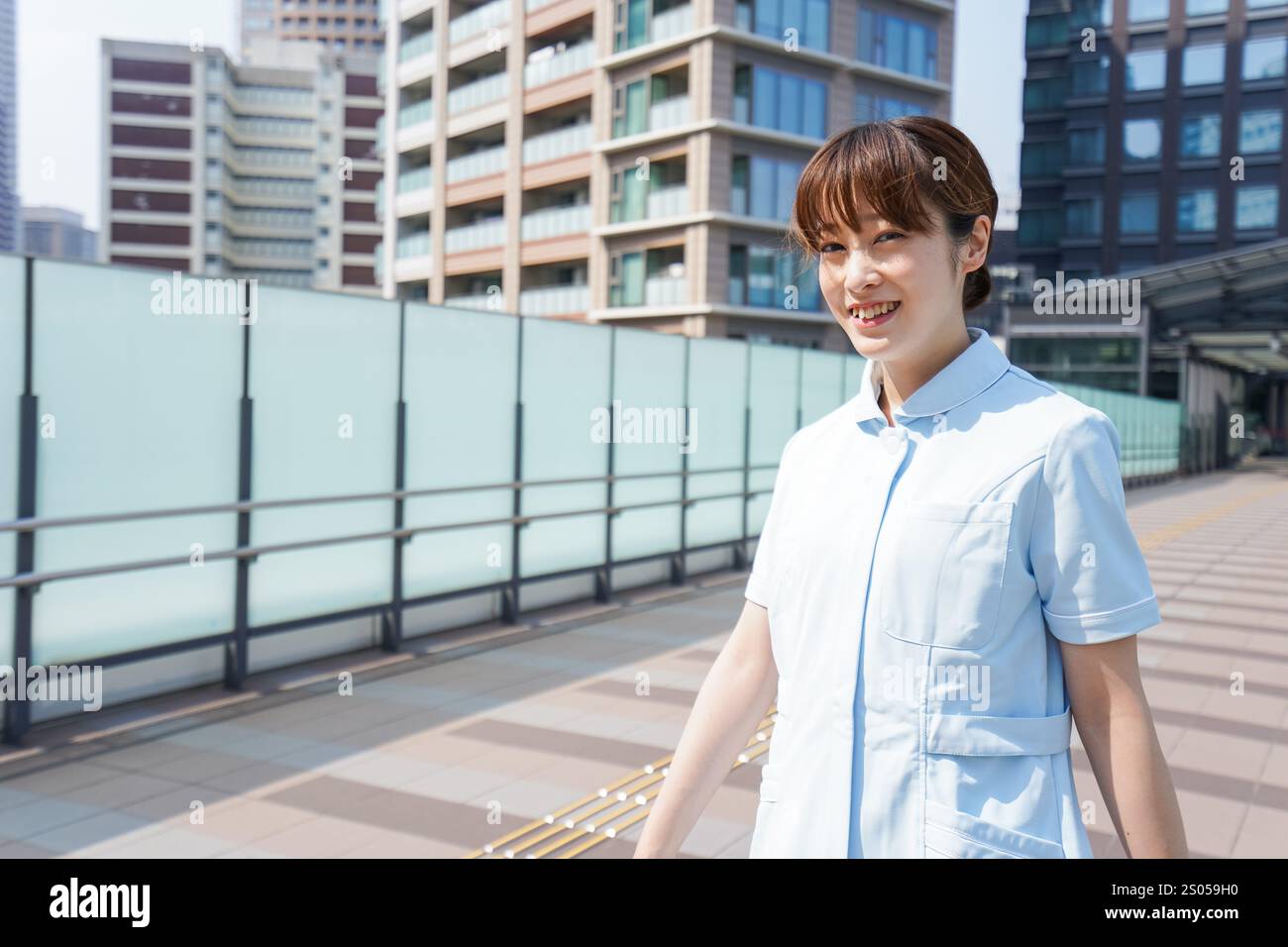 Nurse walking outside Stock Photo - Alamy