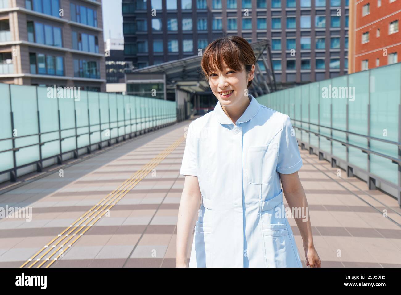 Nurse walking outside Stock Photo - Alamy