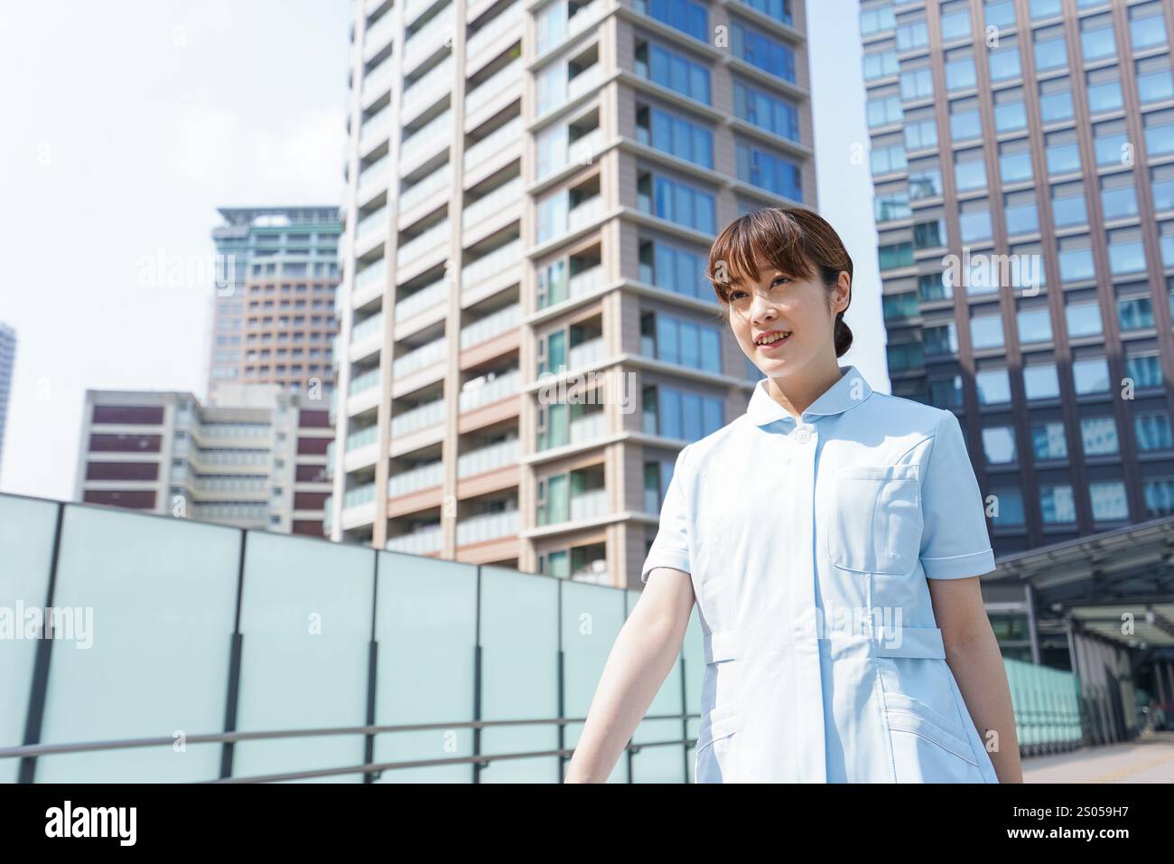 Nurse walking outside Stock Photo - Alamy