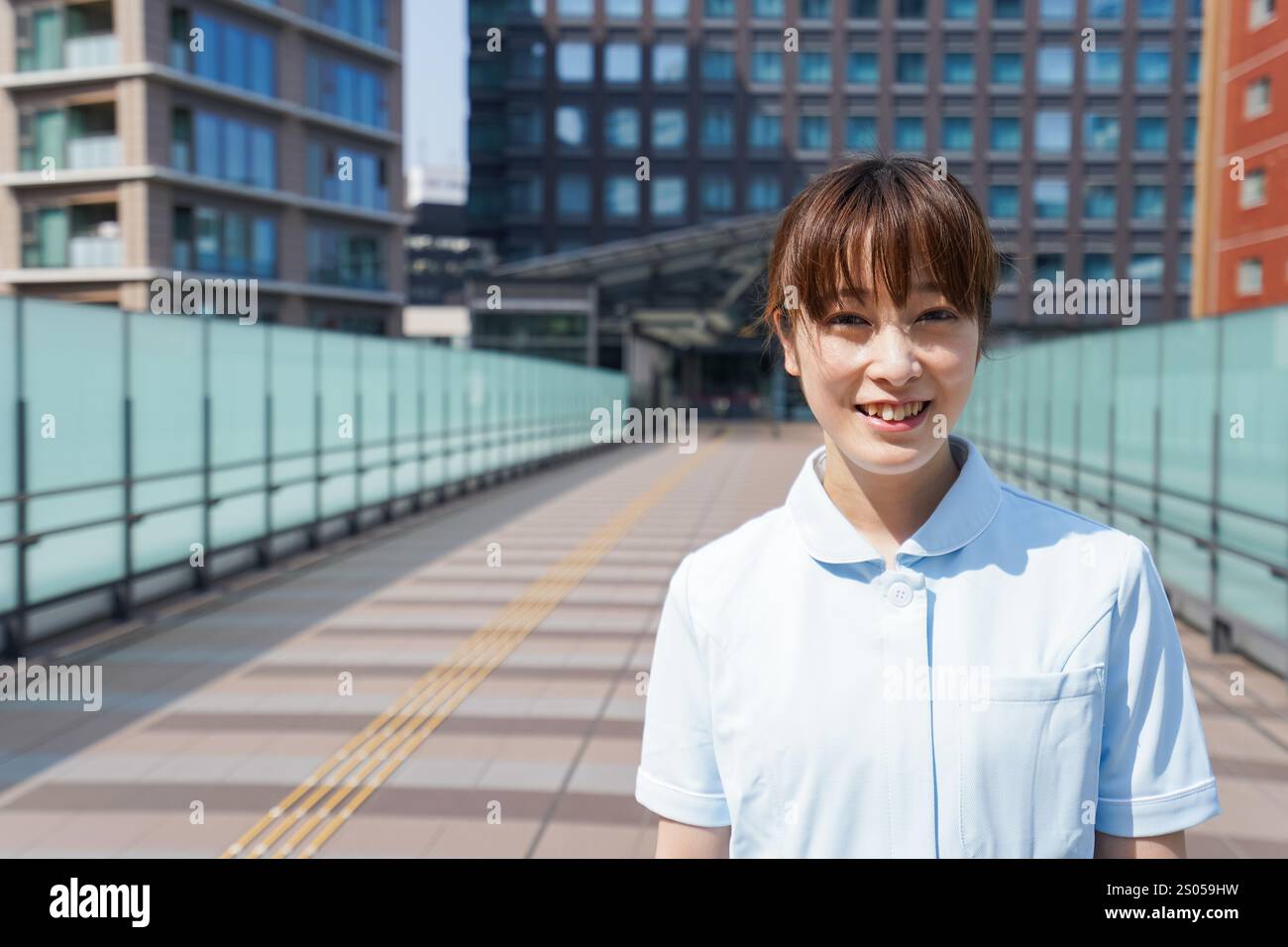 Nurse walking outside Stock Photo - Alamy