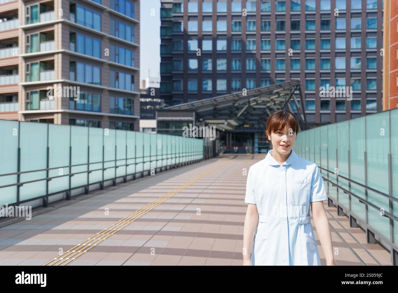 Nurse walking outside Stock Photo - Alamy