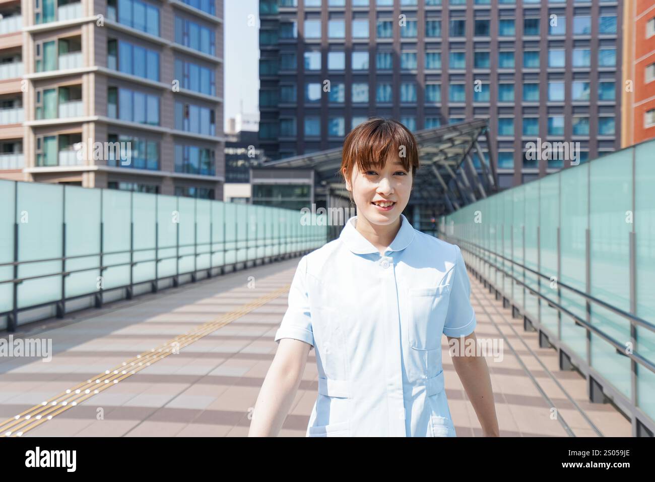 Nurse walking outside Stock Photo - Alamy