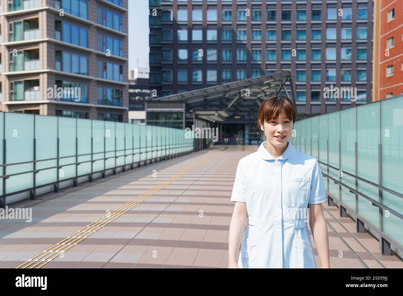 Nurse walking outside Stock Photo - Alamy