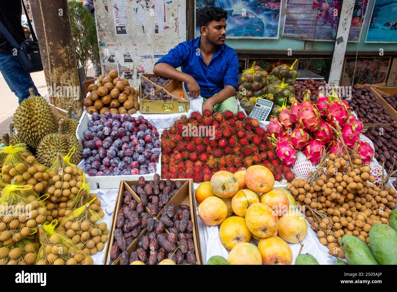 Customers gather at roadside fruit shops in Purana Paltan, Dhaka, where a variety of imported ...