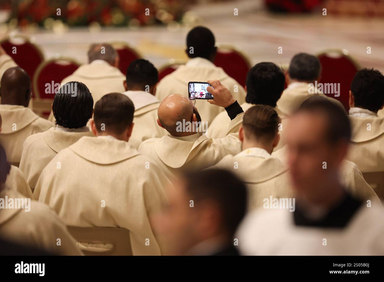 Rome, Italy. 24th Dec, 2024. A priest takes a selfie before the ...