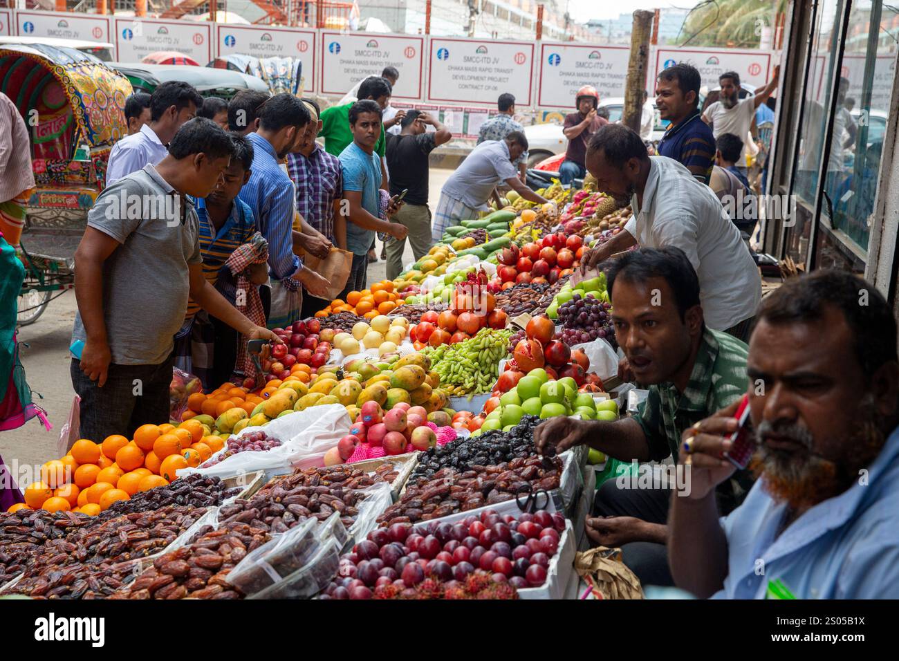 Customers gather at roadside fruit shops in Purana Paltan, Dhaka, where a variety of imported ...