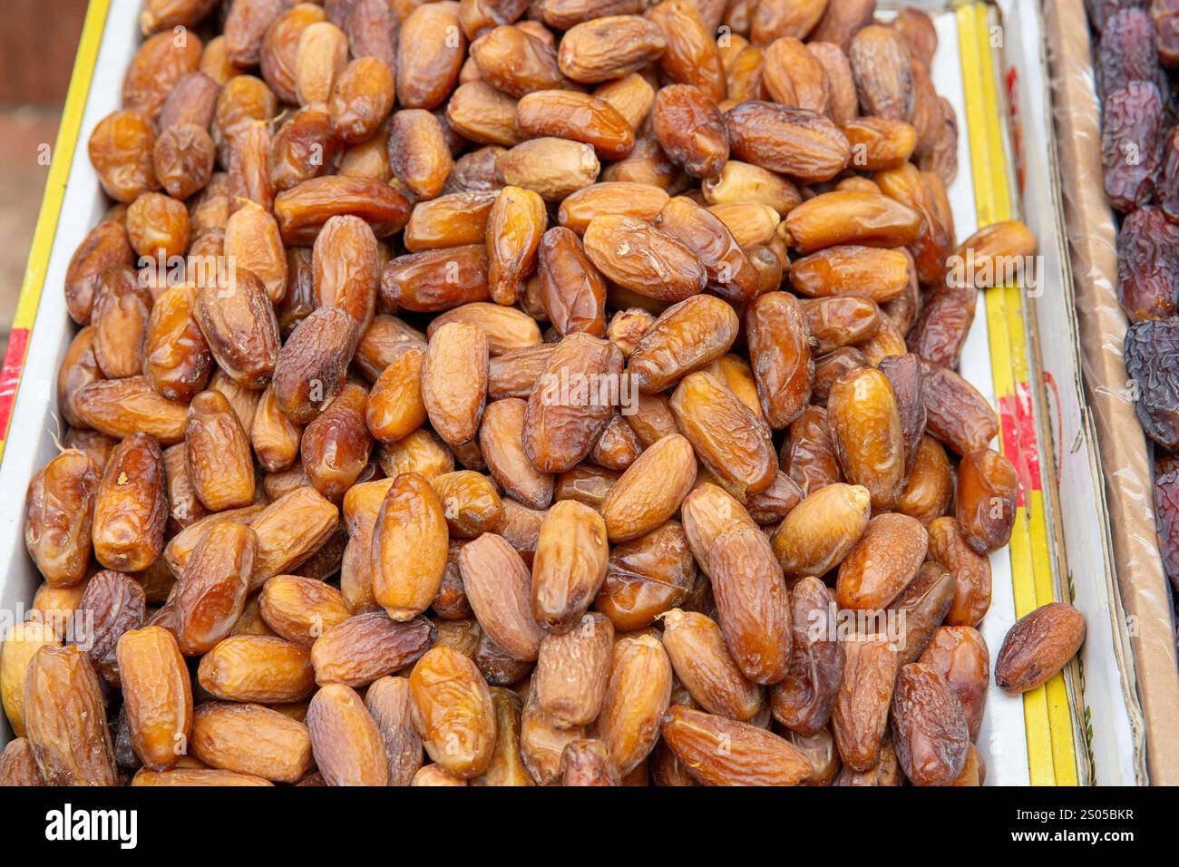 A variety of dates are beautifully displayed at a roadside shop in ...