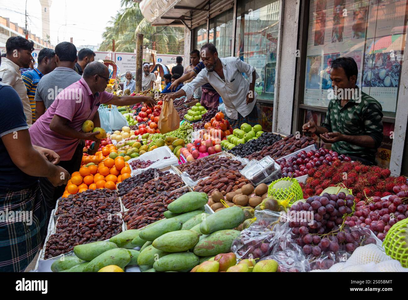 Customers gather at roadside fruit shops in Purana Paltan, Dhaka, where ...