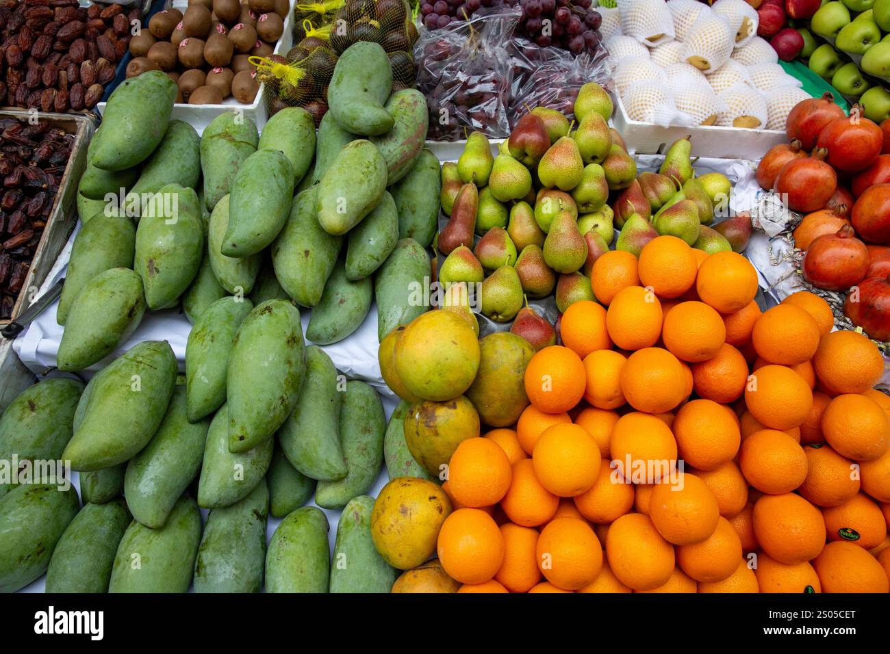 A variety of imported fruits neatly displayed at a roadside shop in ...