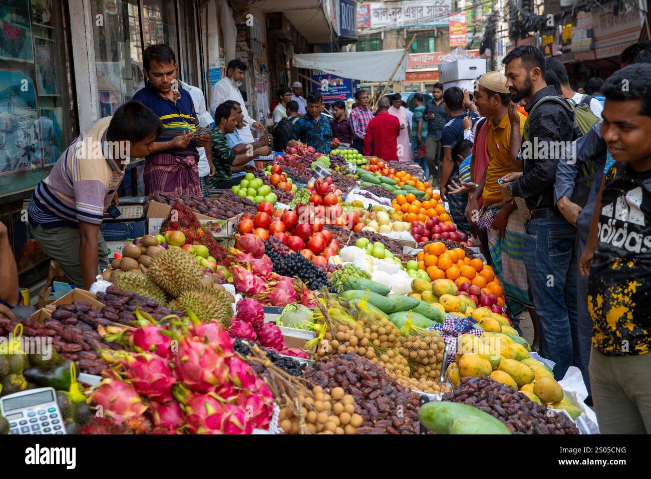 Customers gather at roadside fruit shops in Purana Paltan, Dhaka, where a variety of imported ...