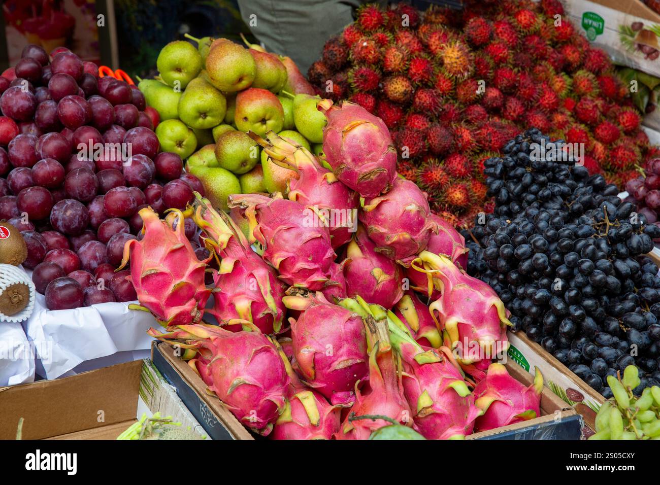 A variety of imported fruits neatly displayed at a roadside shop in ...