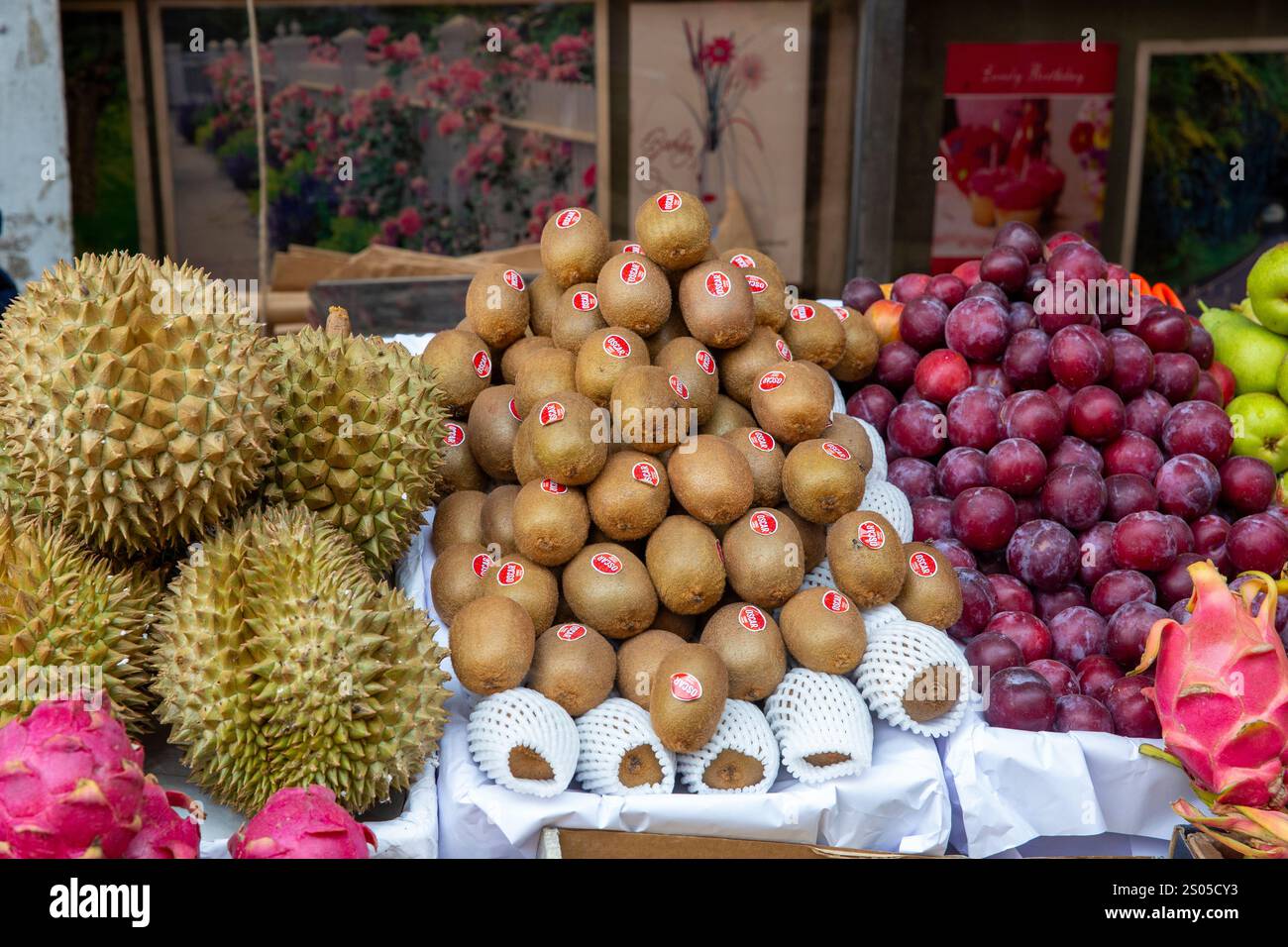 A variety of imported fruits neatly displayed at a roadside shop in ...