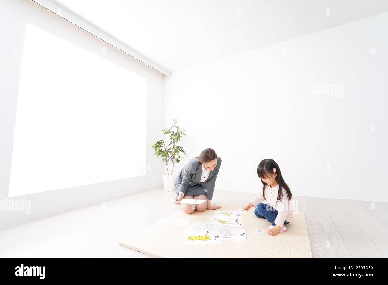 Children taking lessons from a native teacher in an English language ...