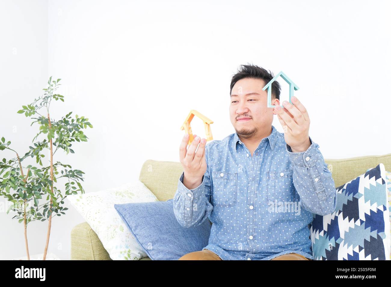 Man comparing real estate Stock Photo - Alamy