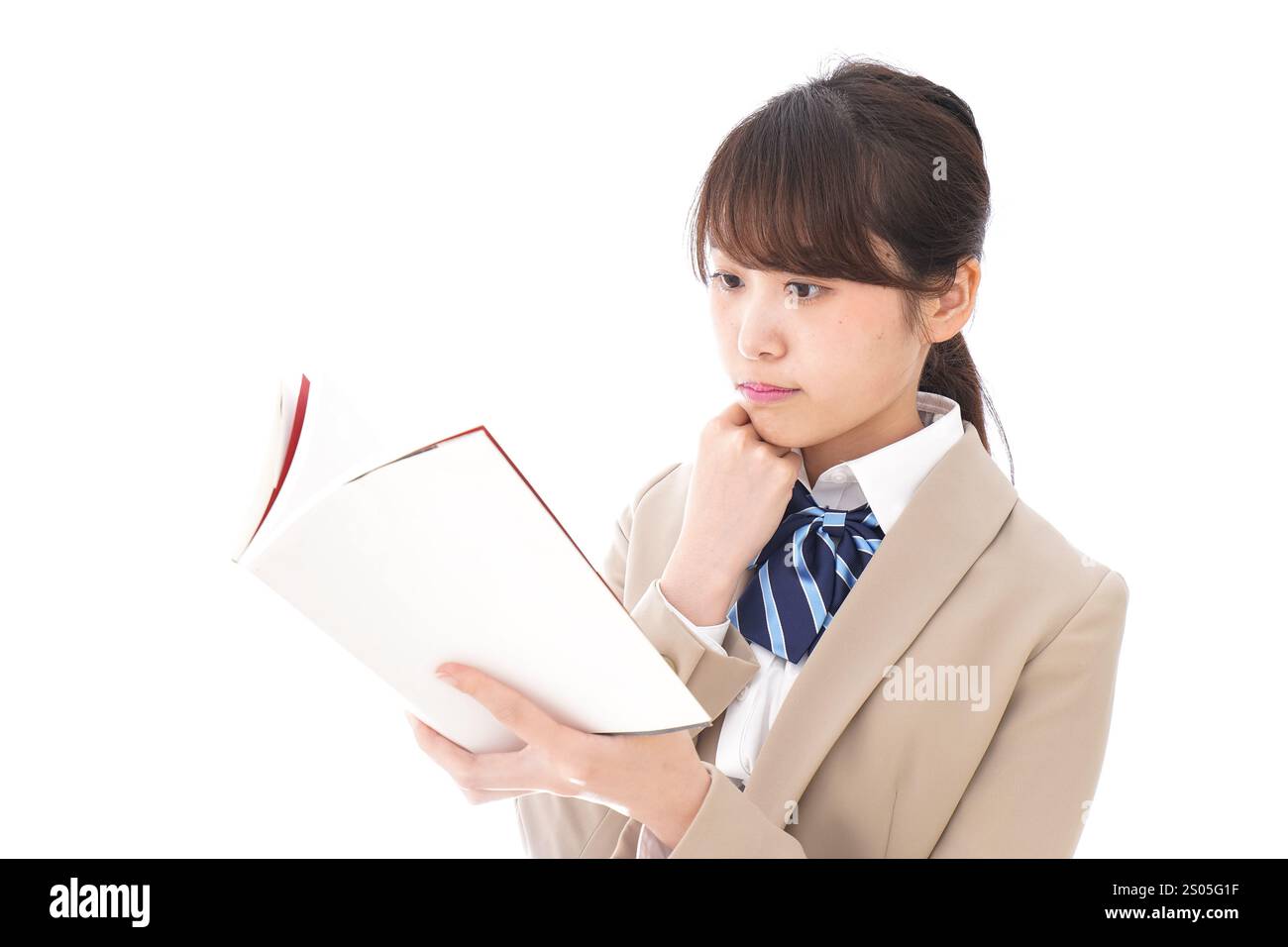 Student in uniform reading Stock Photo - Alamy