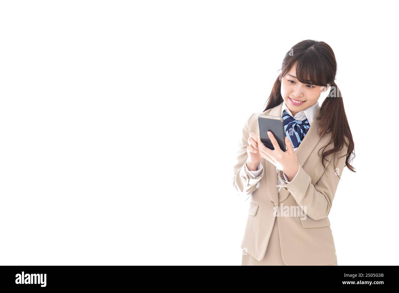 Student in school uniform using a smartphone app Stock Photo - Alamy
