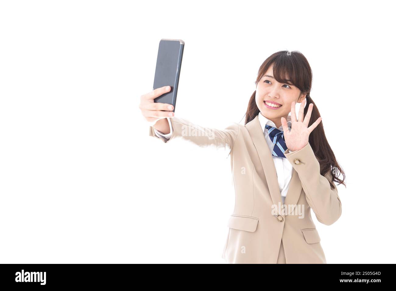 Student in school uniform using a smartphone Stock Photo - Alamy